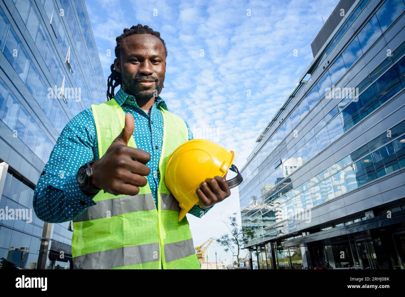 happy positive young civil engineer man of African ethnicity with beard ...