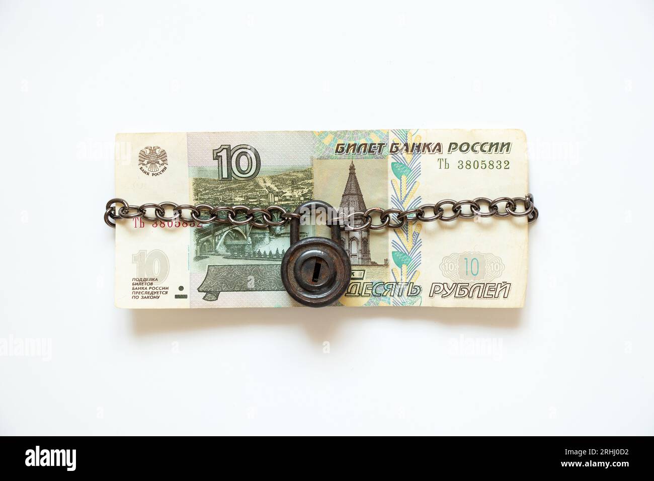 Ten Russian rubles on a chain under lock and key on a white background ...