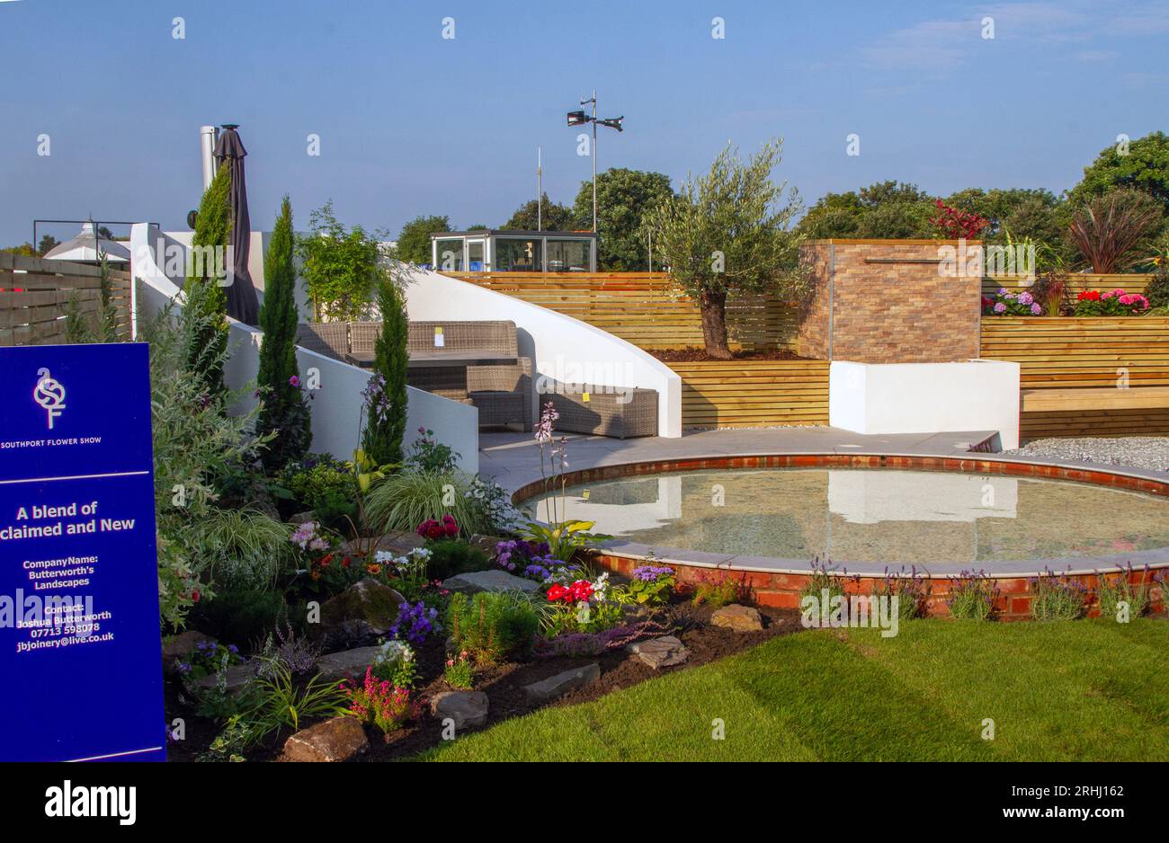 Circular garden pool retreat, Patio with wooden seating & rockery. A ...