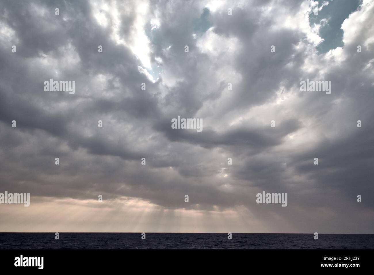 Grey sky with clouds and ocean Stock Photo - Alamy