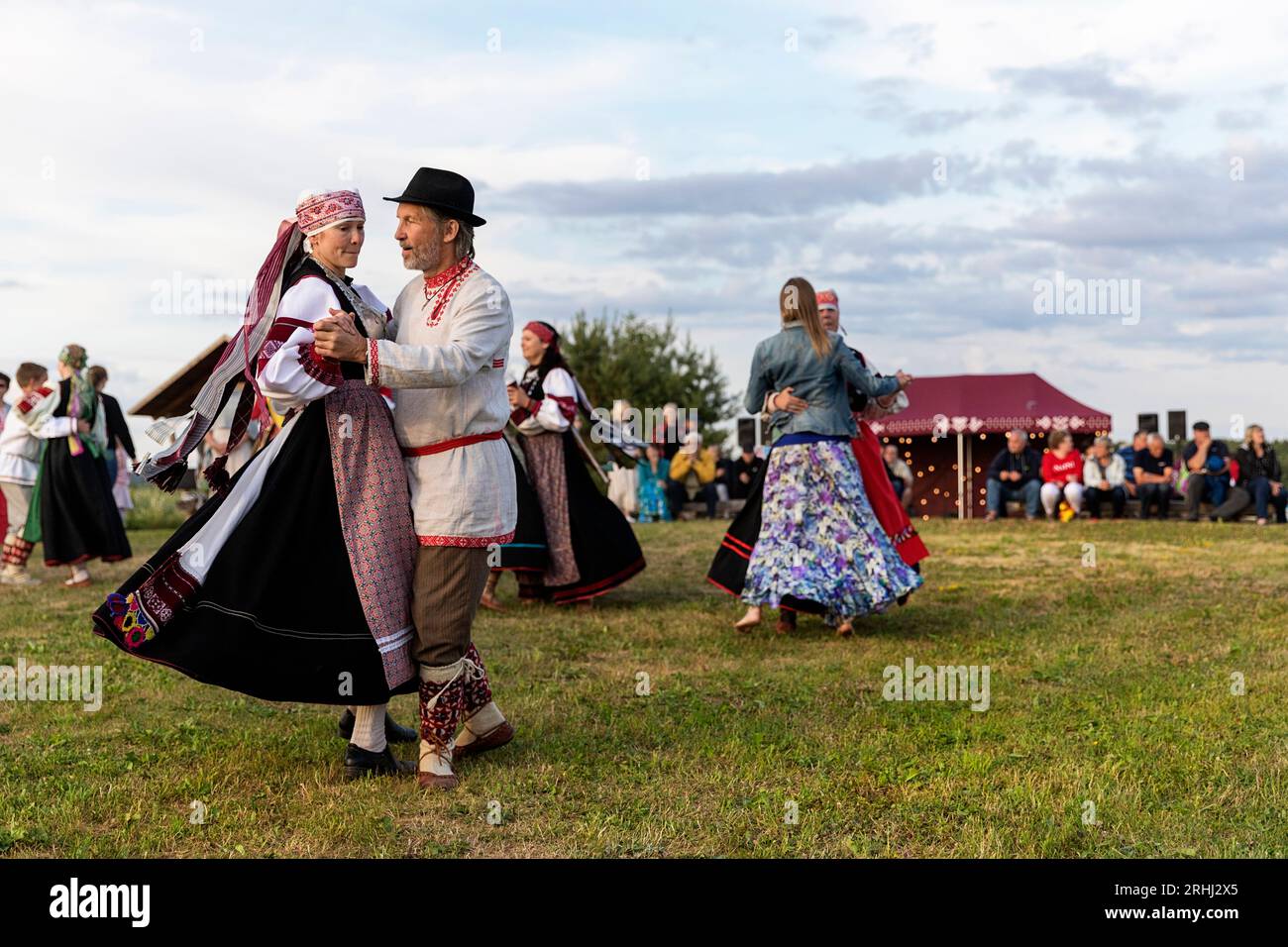 Locals in traditional seto estonian folk costumes dancing, celebrating ...