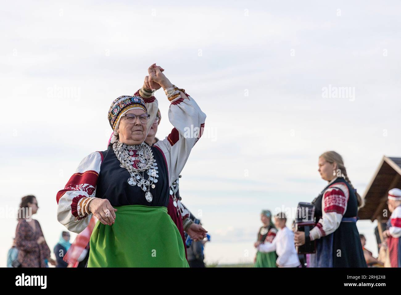 Locals in traditional seto estonian folk costumes dancing, celebrating ...