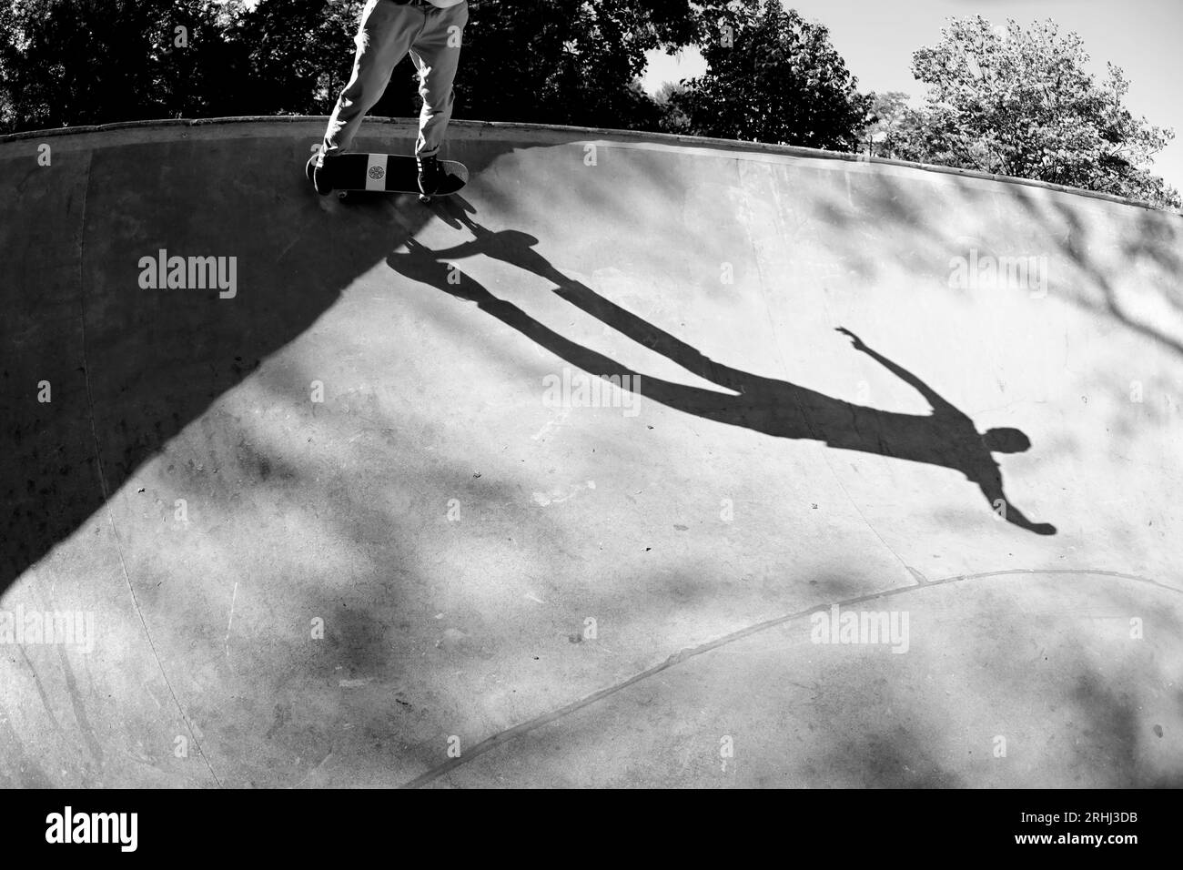 silhouette shadow of a skateboarder at a skatepark black and white ...