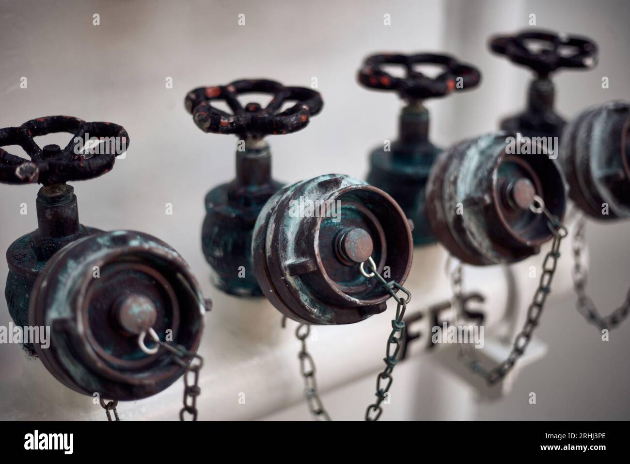 Rusty brass fire hydrant valves with plugs to connect to water hose ...