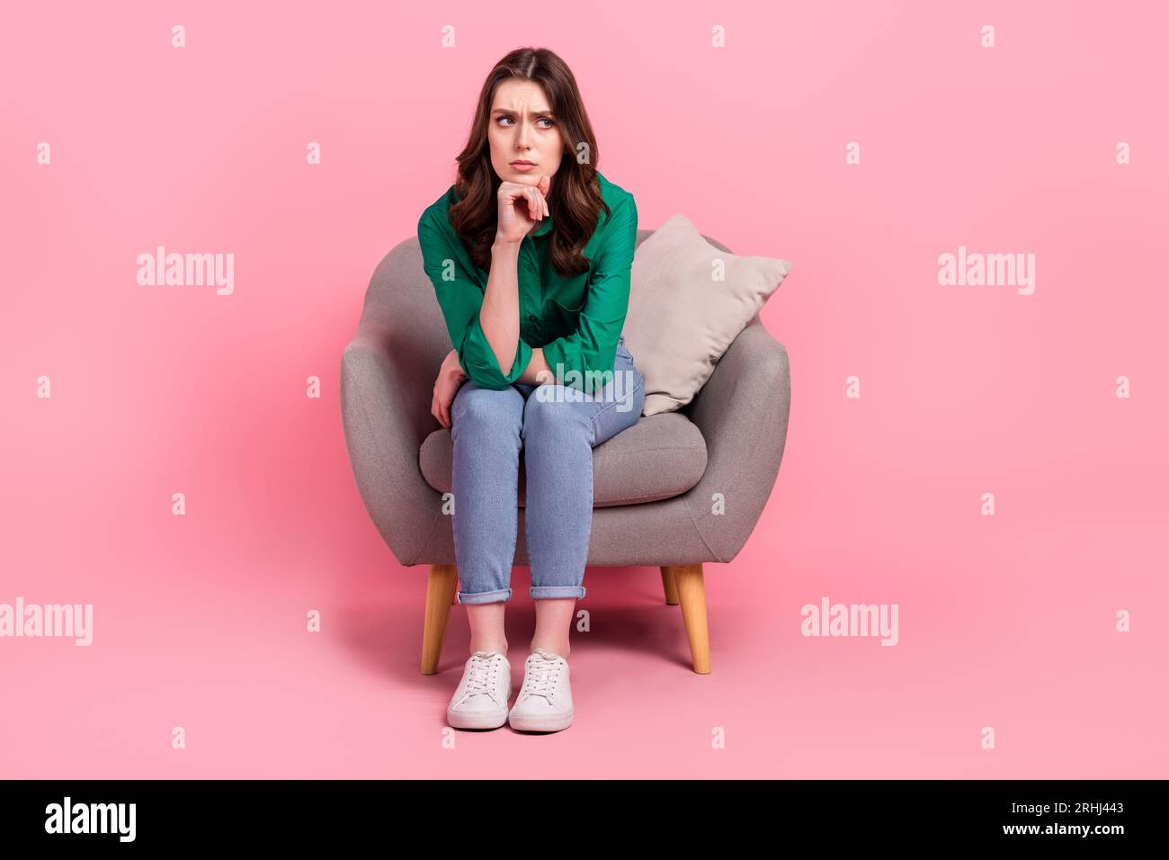 Full body photo of unsatisfied miserable lady sit chair hand touch chin ...