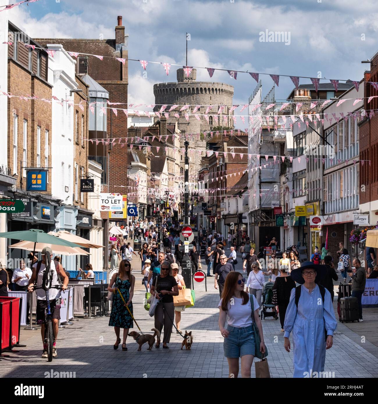 The Round Tower of Windsor Castle looms over the town's main shopping ...