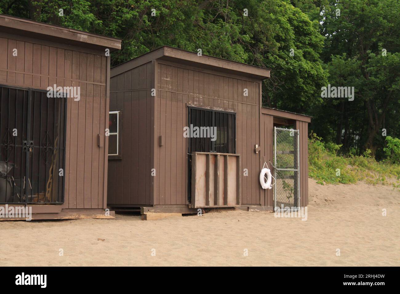 Utility building on the beach with life preserver Stock Photo - Alamy
