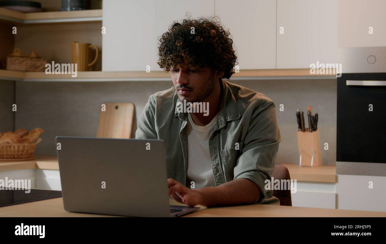 Concentrated Indian businessman typing computer working shopping online ...