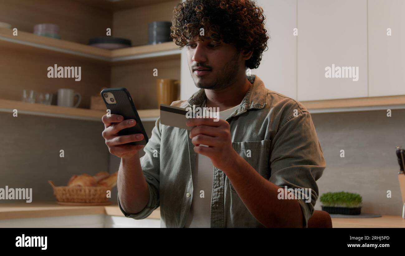 Indian male customer man Arabian guy homeowner sitting at kitchen order ...
