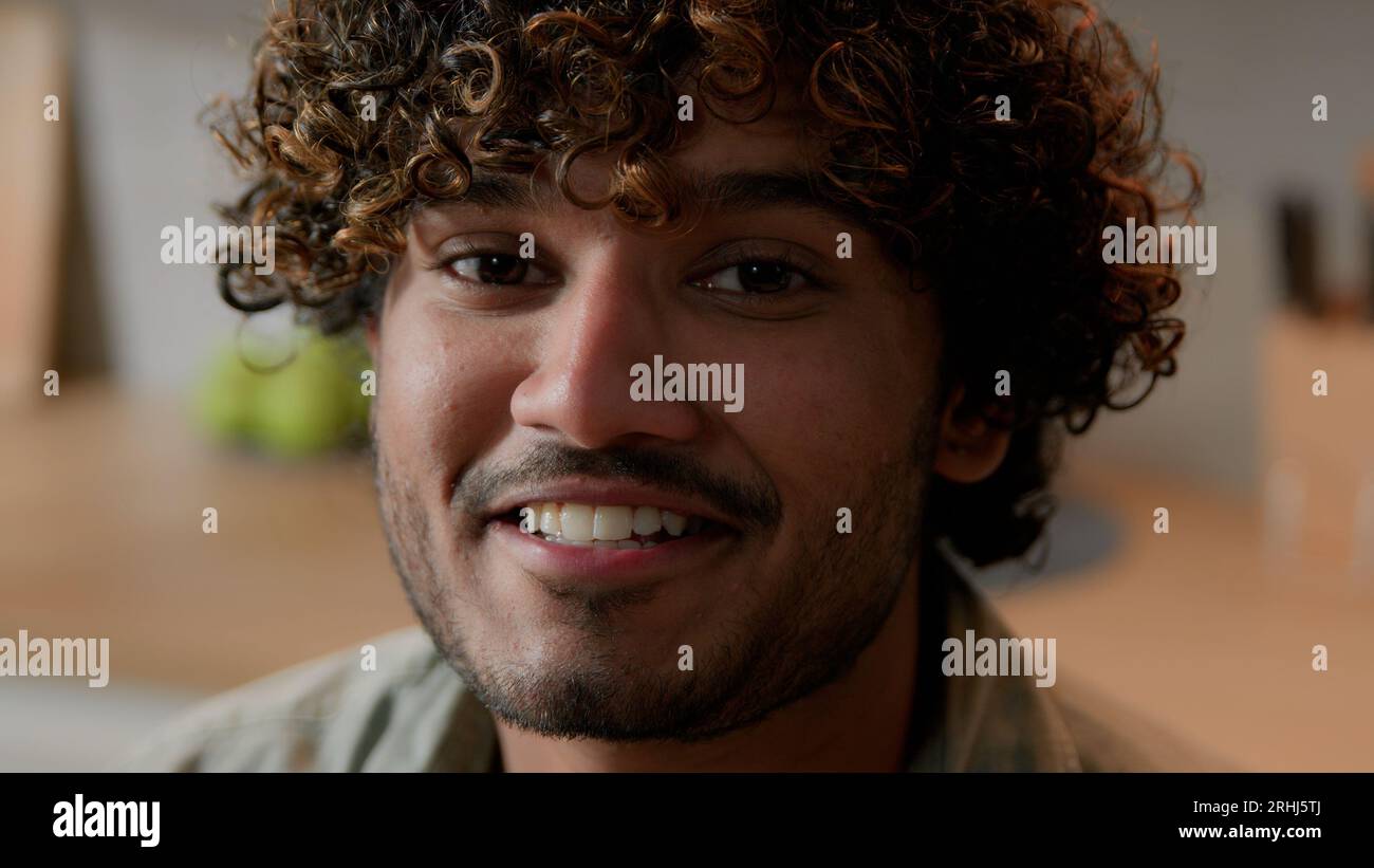 Close up smiling Arabian man homeowner with curly hair vlogger look at ...