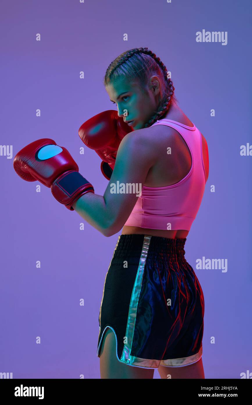 Serious teen girl, MMA fighter in sportswear and boxing gloves training ...