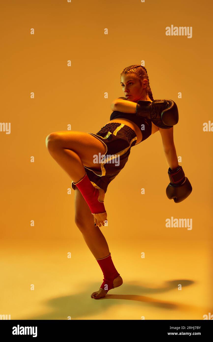 Dynamic photo of athletic teen girl, mma fighter in sportswear training ...