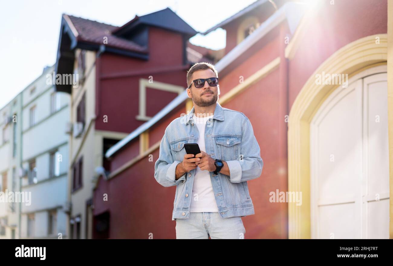 Man standing using phone hi-res stock photography and images - Alamy