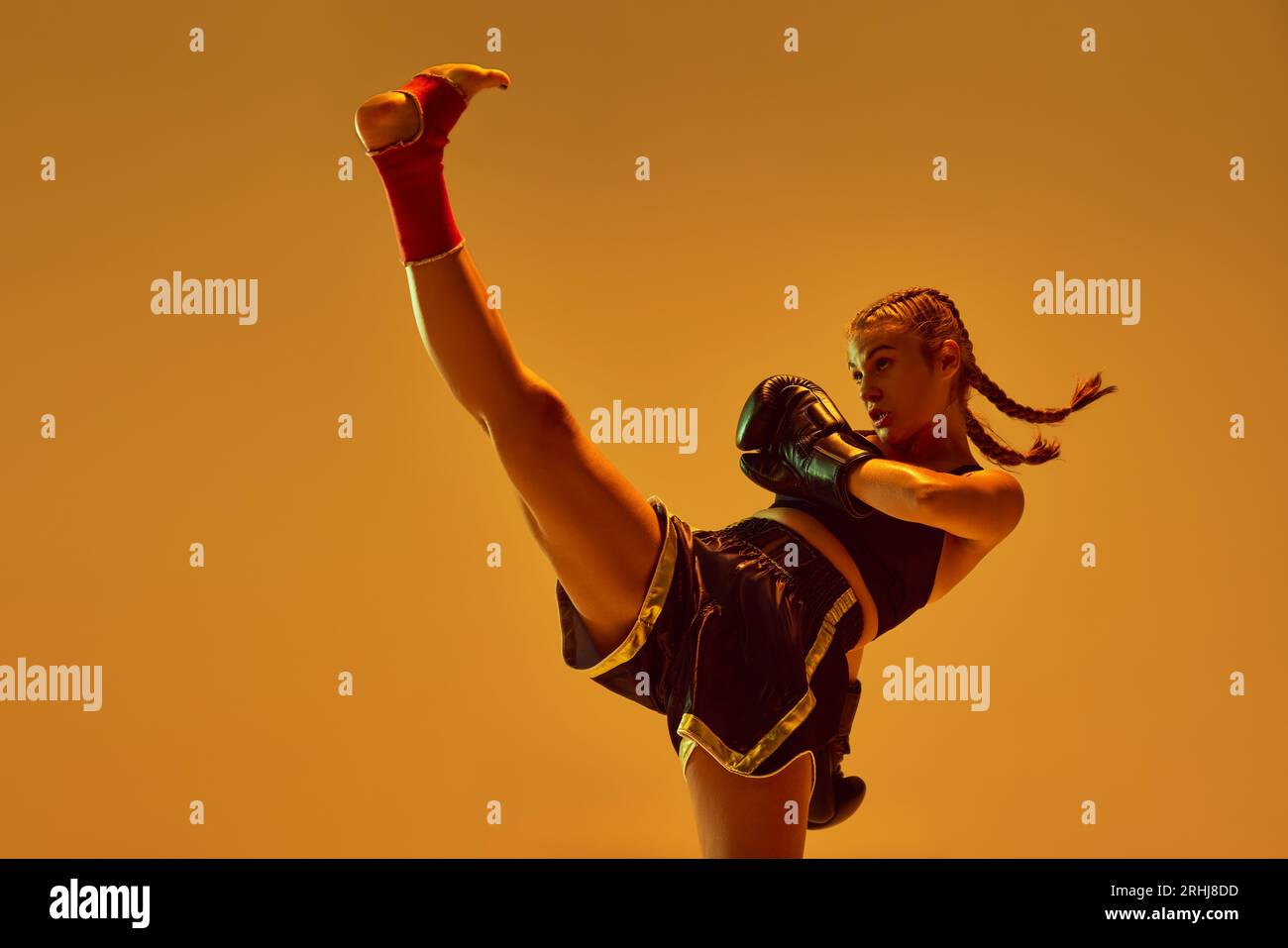 Strong legs. MMA fighter, teen girl training, kicking with leg against ...