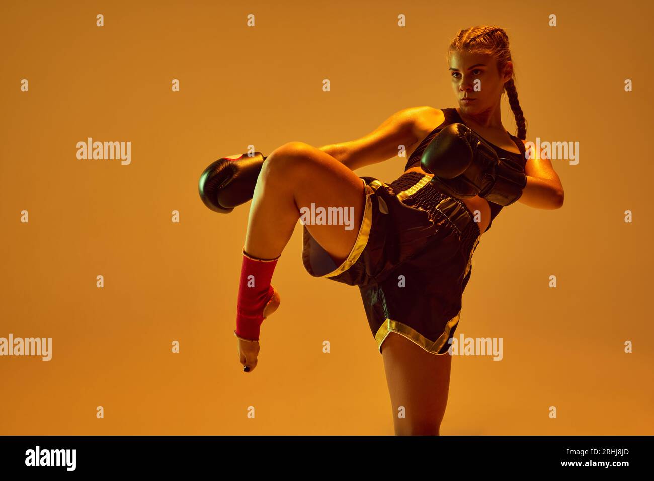 Strong legs. MMA fighter, teen girl training, kicking with leg against ...