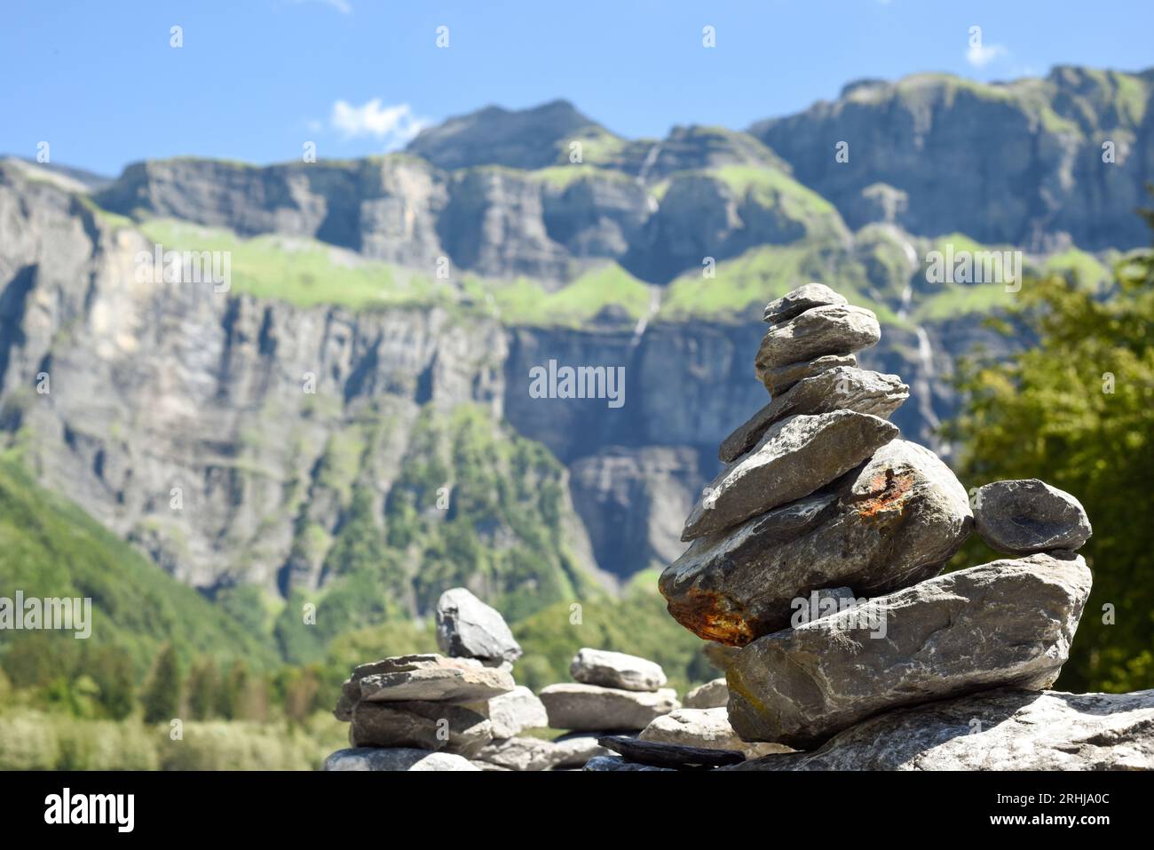 Stack of balancing rocks symbolising peace and mindfulness over a lush ...