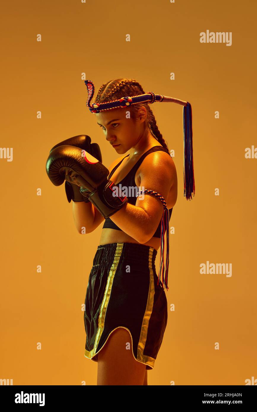 Defense position. Teen girl, concentrated MMA athlete in boxing gloves ...