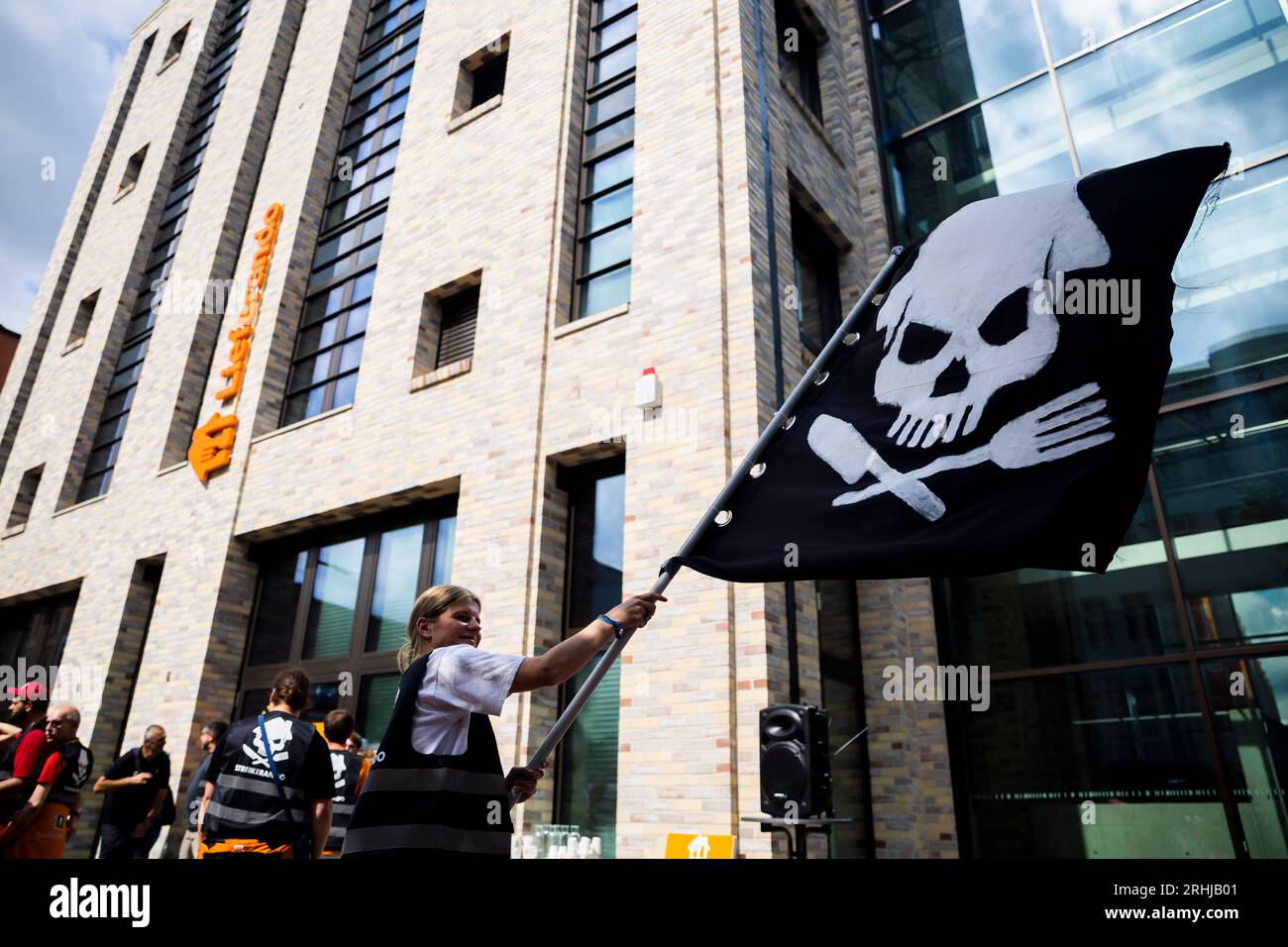 Berlin, Germany. 17th Aug, 2023. A woman waves a flag with the ...