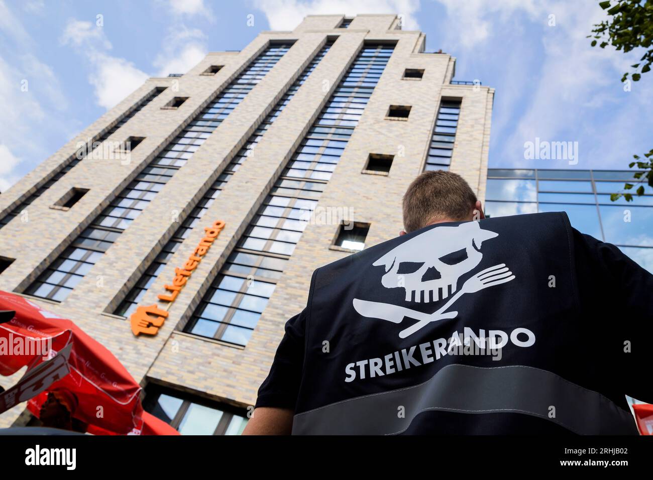 Berlin, Germany. 17th Aug, 2023. A participant stands in front of the ...