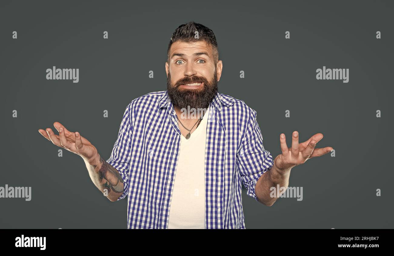puzzled bearded man wear checkered shirt on grey background Stock Photo ...
