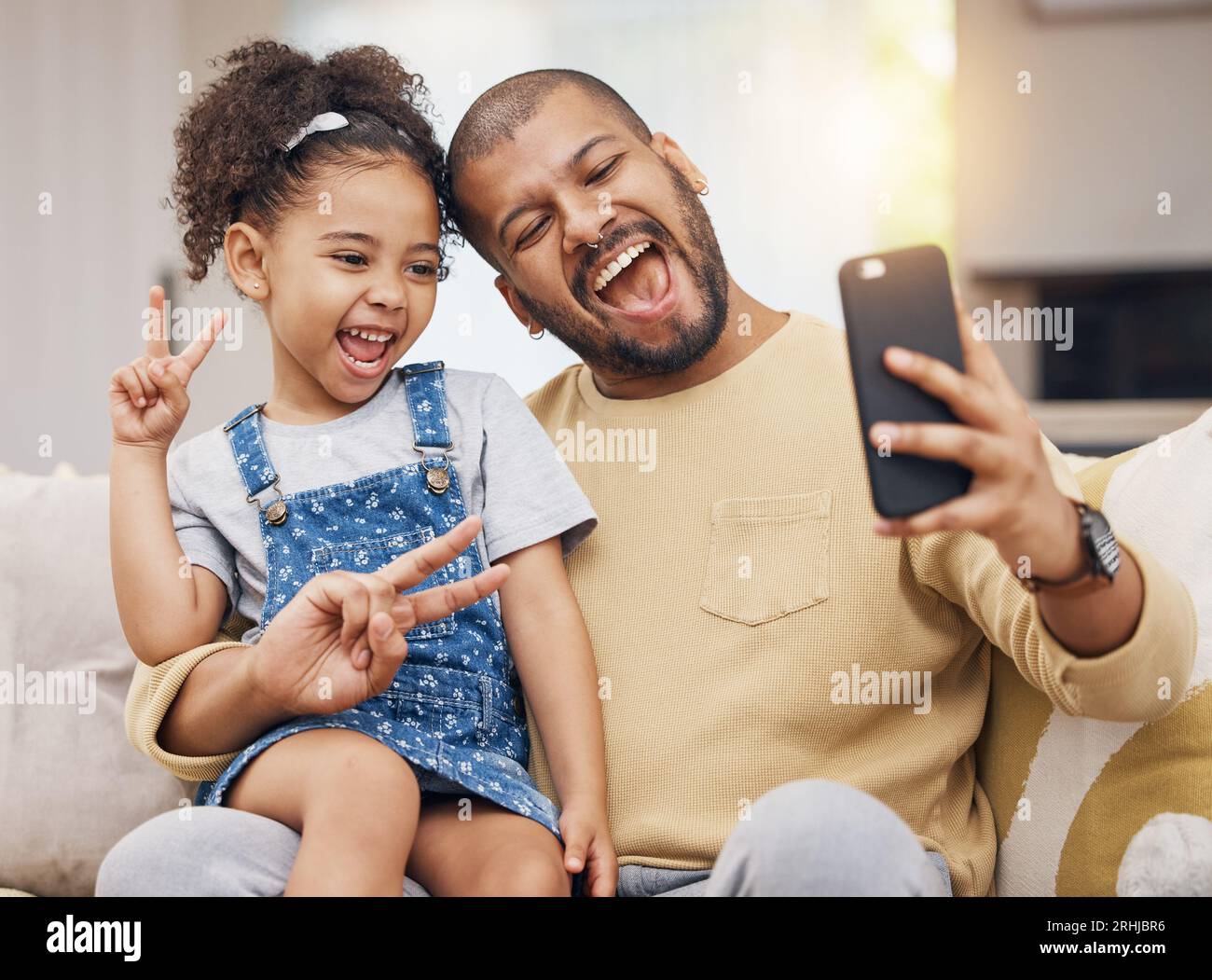 Father, girl and peace sign selfie in home living room, bonding and ...