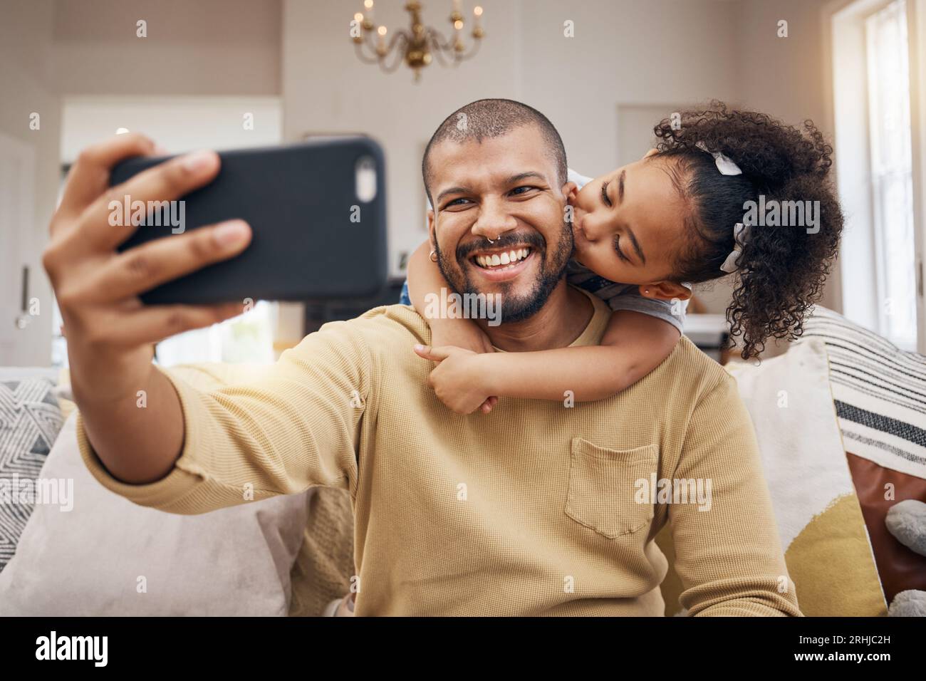 Father, girl and selfie kiss in home living room, bonding and having ...