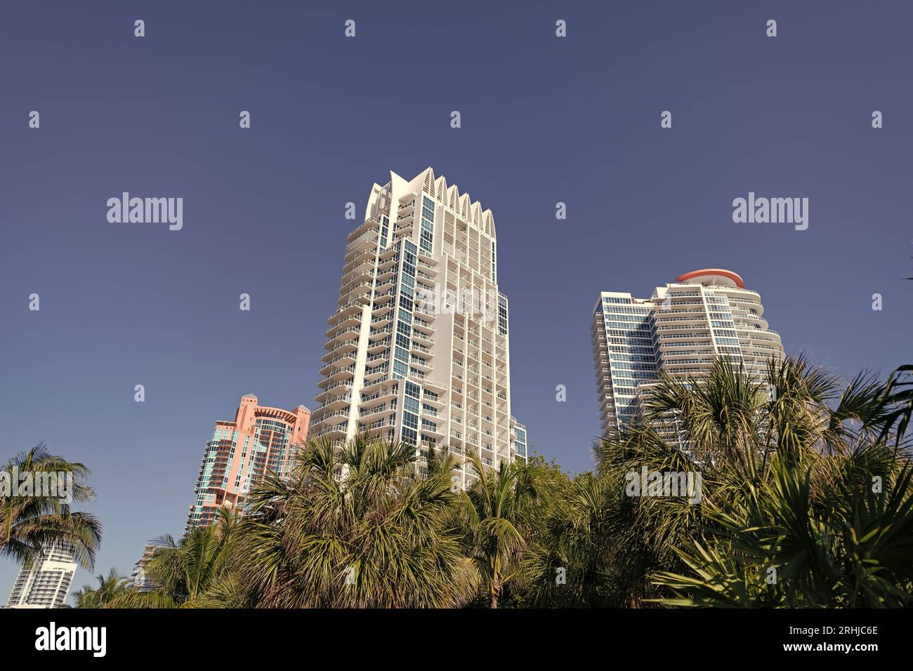 Modern towerblocks high-rise buildings architecture and palms on blue ...