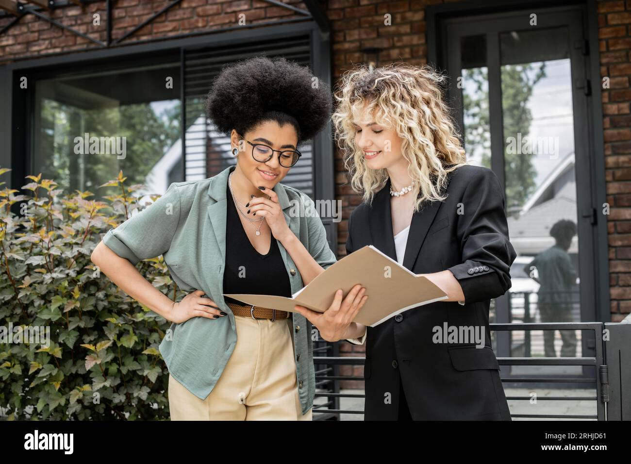 property agent showing documents to african american client standing ...