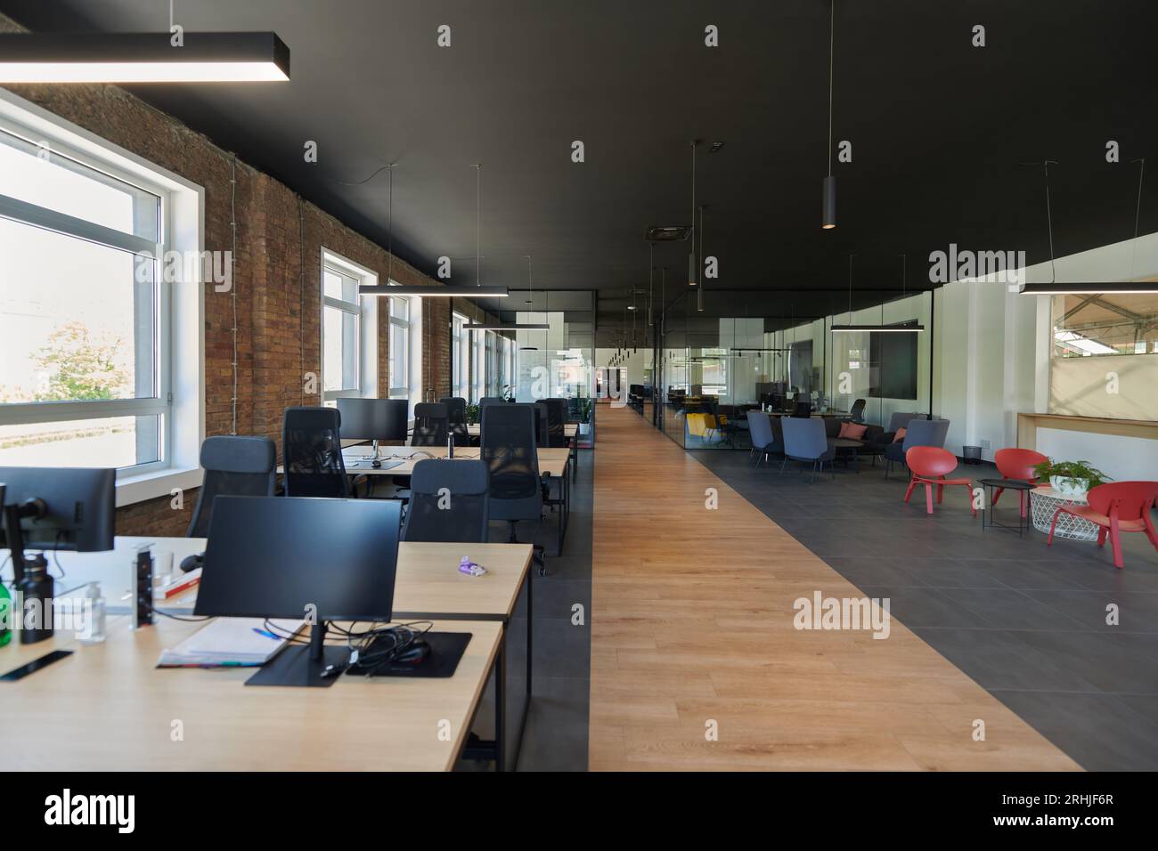 In a setting of modern, glass-walled business startup offices, the open ...