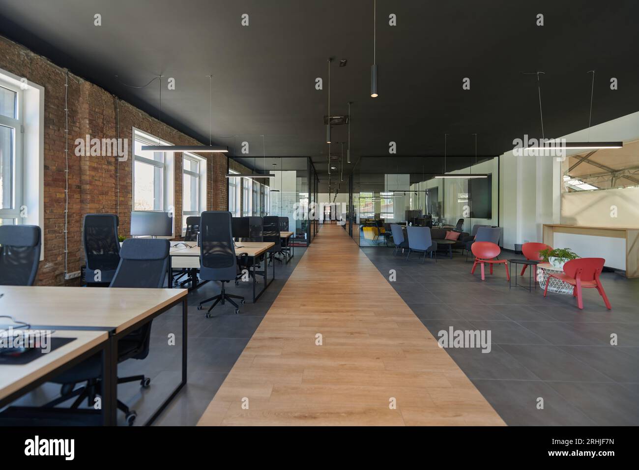 In a setting of modern, glass-walled business startup offices, the open ...