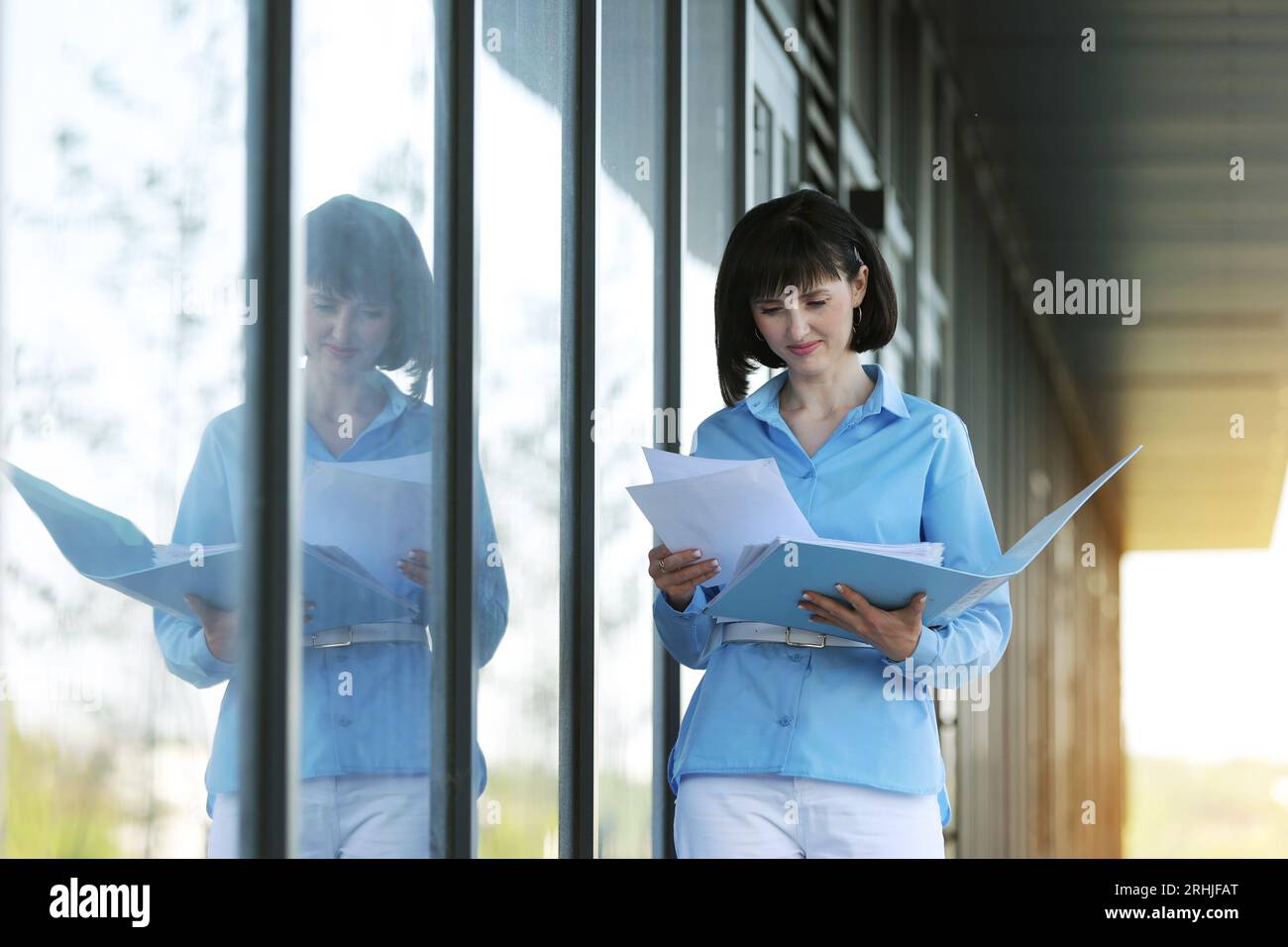 Multitasking busy young business woman during walks reading and ...