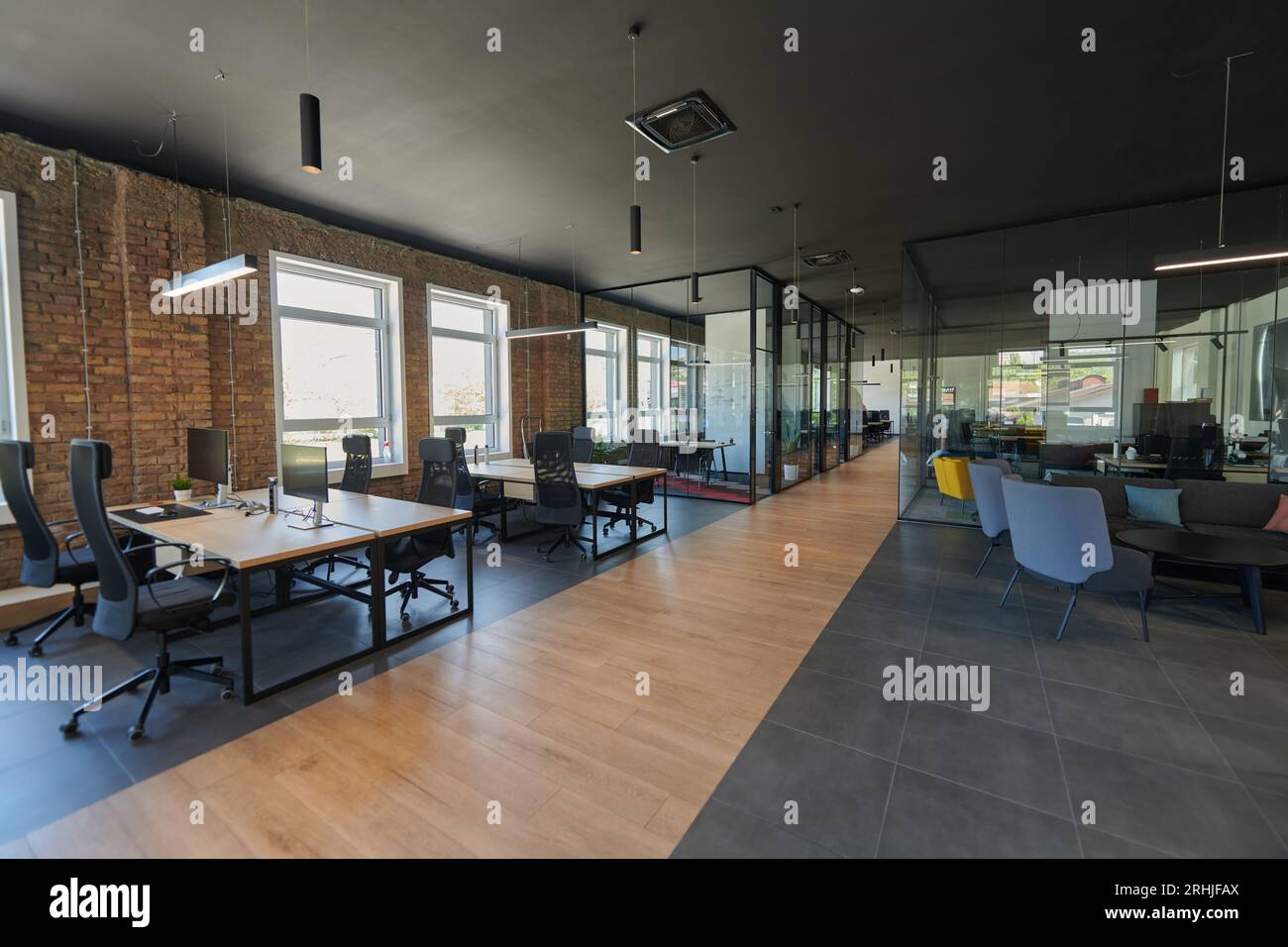 In a setting of modern, glass-walled business startup offices, the open ...