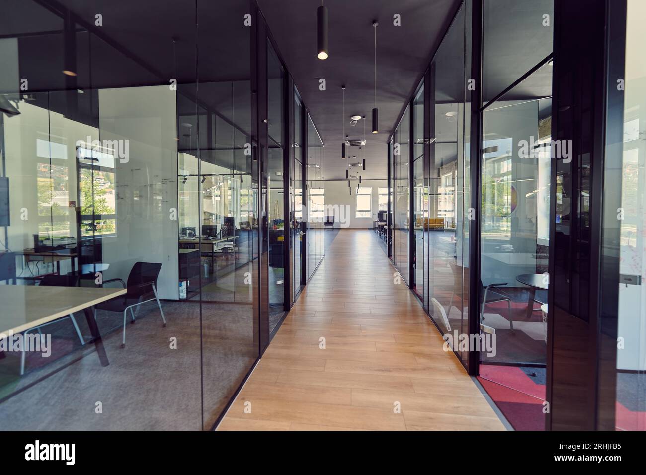 In a setting of modern, glass-walled business startup offices, the open ...