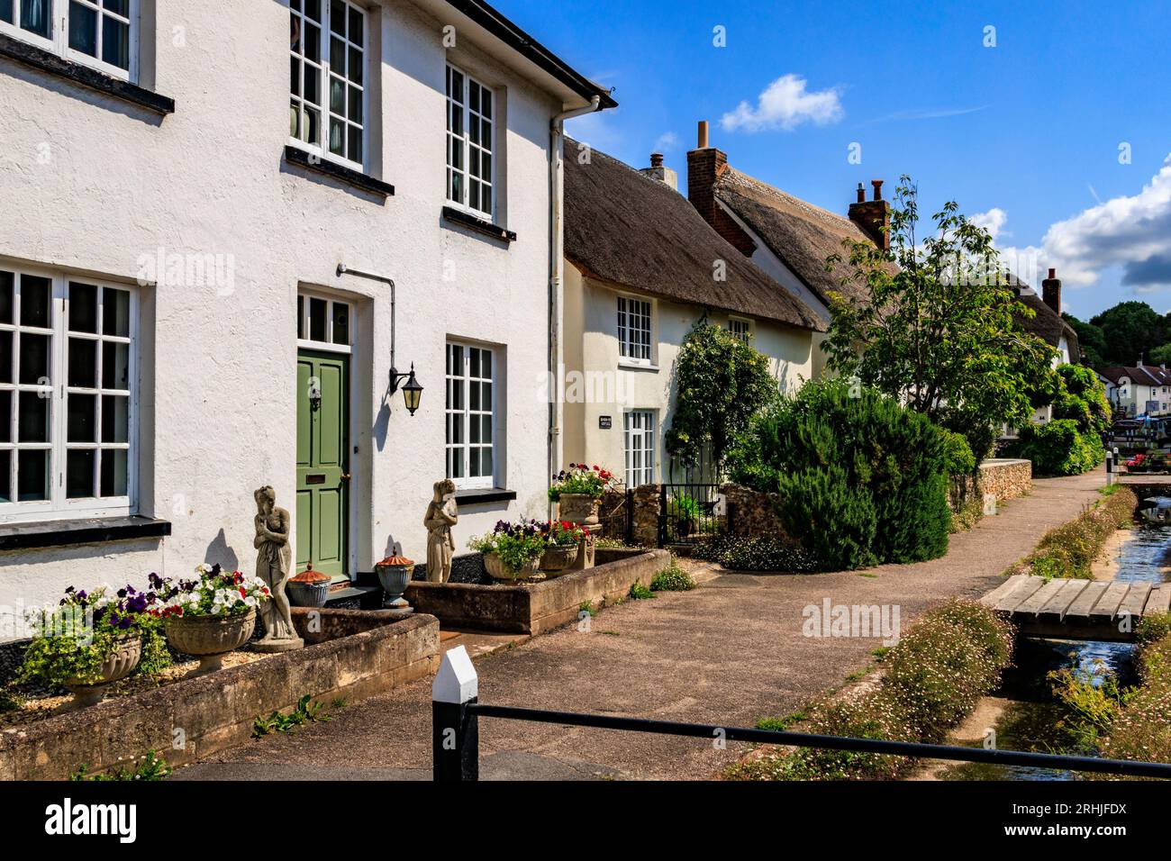 Thatched cottages and well maintained gardens line the main street in ...