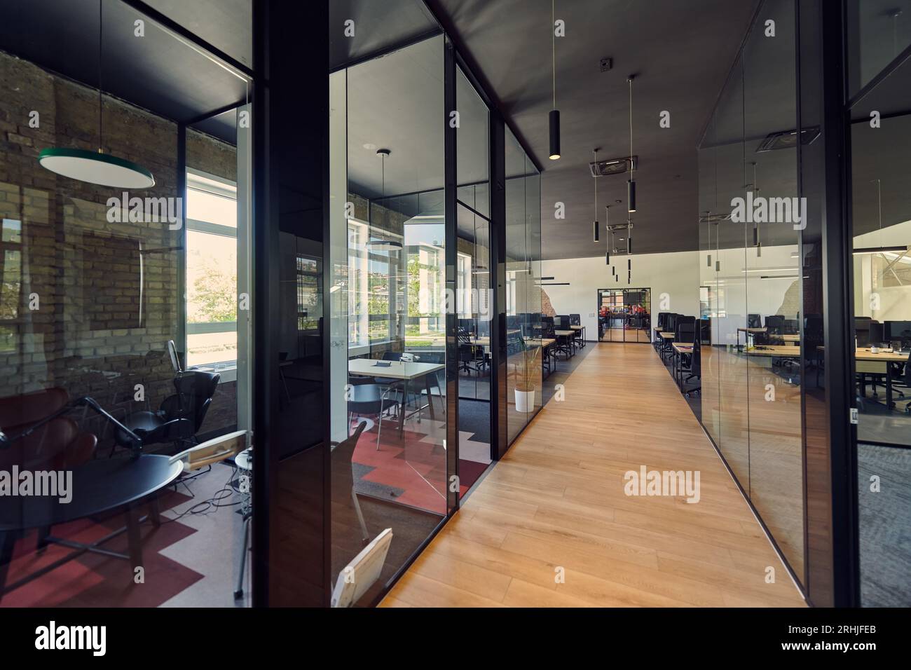 In a setting of modern, glass-walled business startup offices, the open ...