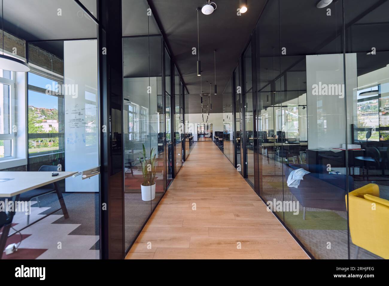 In a setting of modern, glass-walled business startup offices, the open ...