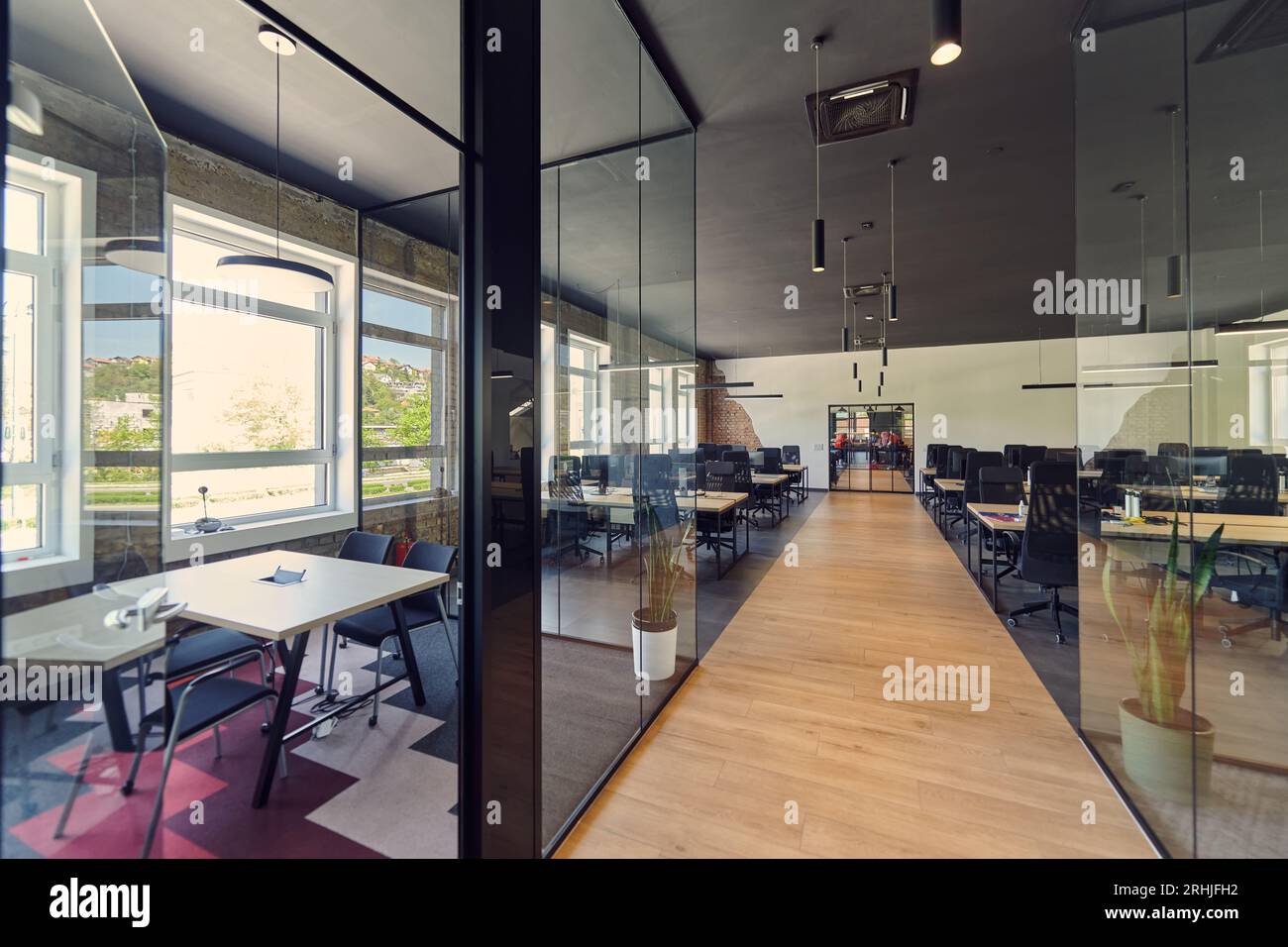 In a setting of modern, glass-walled business startup offices, the open ...