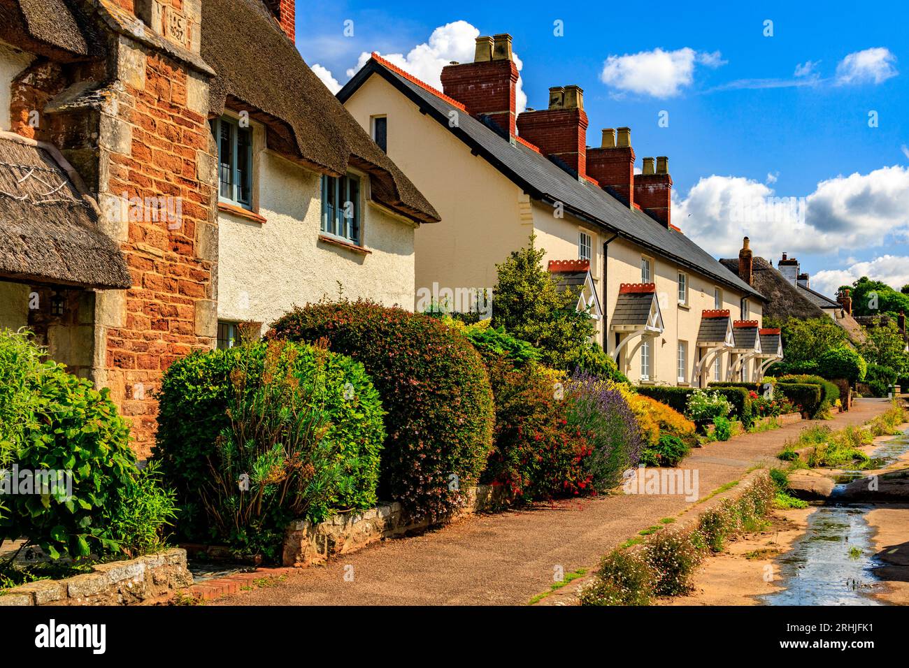 Colourful cottages and well maintained gardens line the main street in ...