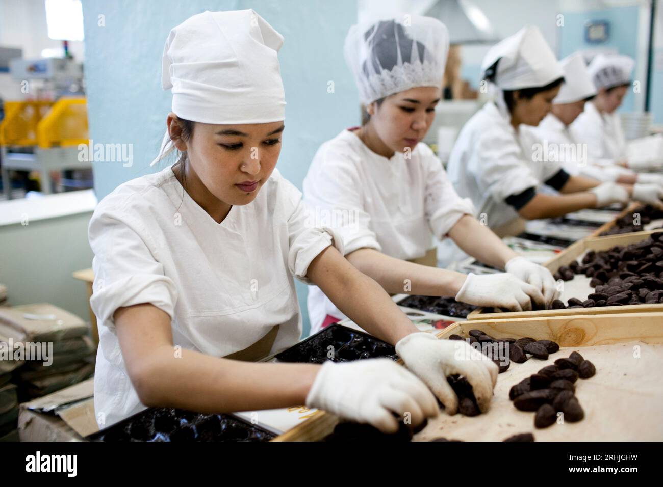 Women work the packaging line inside the Rakhat chocolate factory in ...