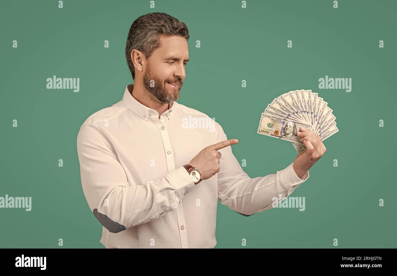 millionaire point finger on money isolated on blue background ...