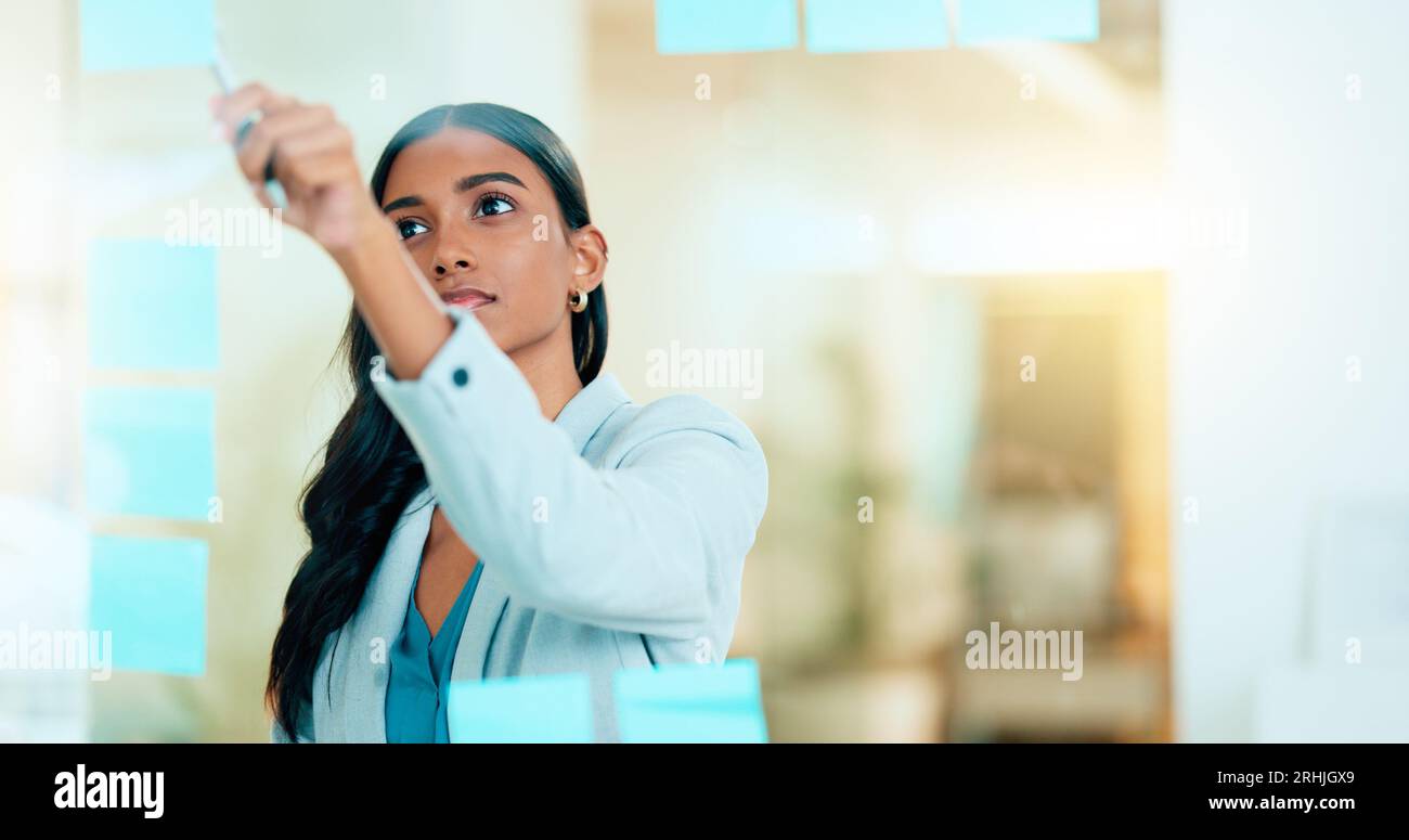 A smart female entrepreneur planning the strategy of her company in the ...