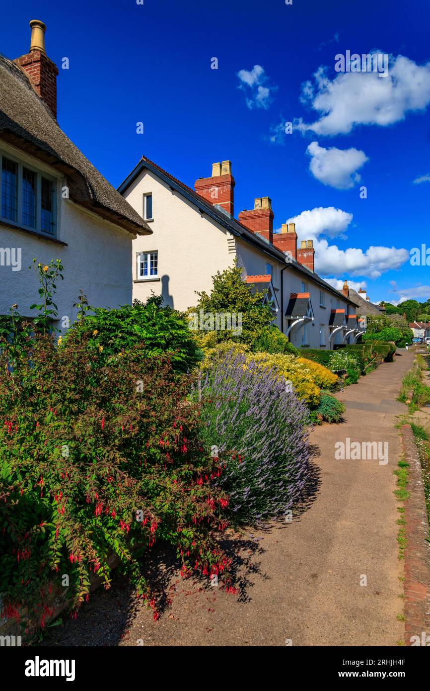 Colourful cottages and well maintained gardens line the main street in ...