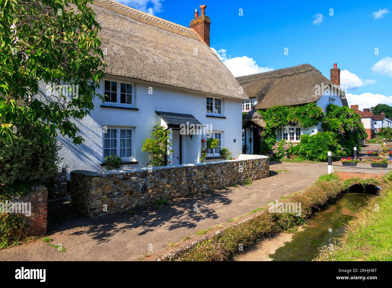 Thatched cottages in the main street in Otterton, Devon, England, UK ...