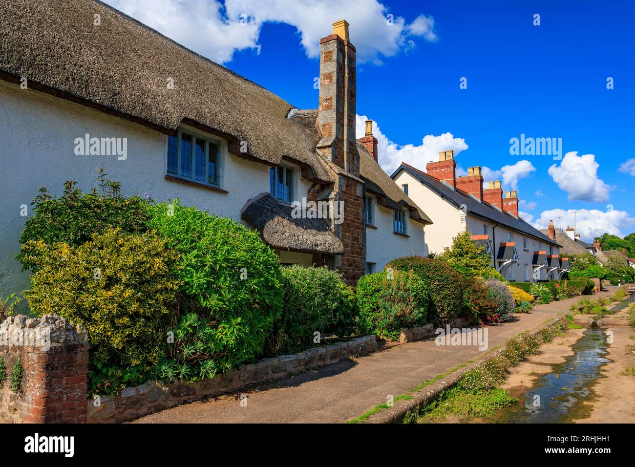 Colourful cottages and well maintained gardens line the main street in ...