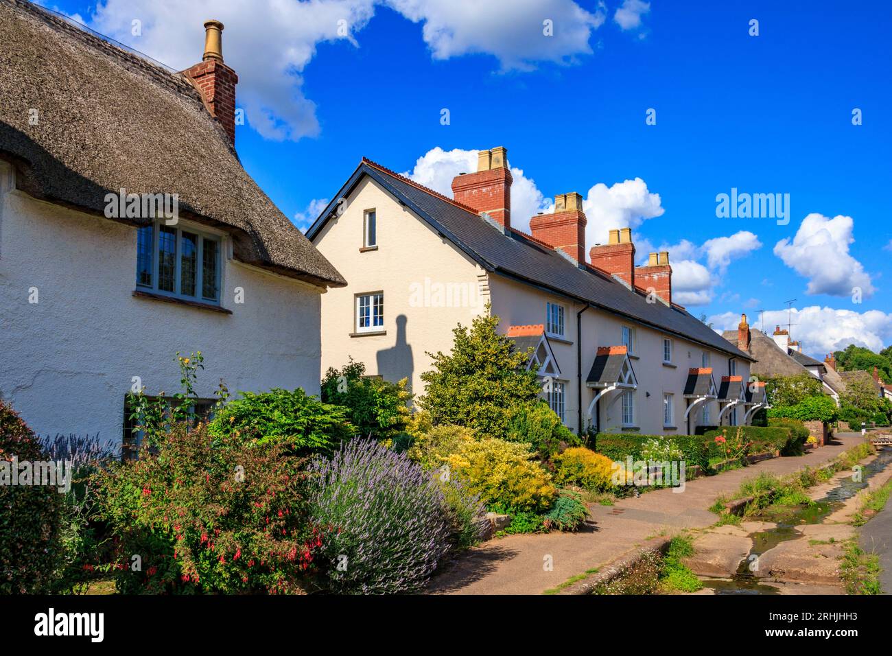 Colourful cottages and well maintained gardens line the main street in ...