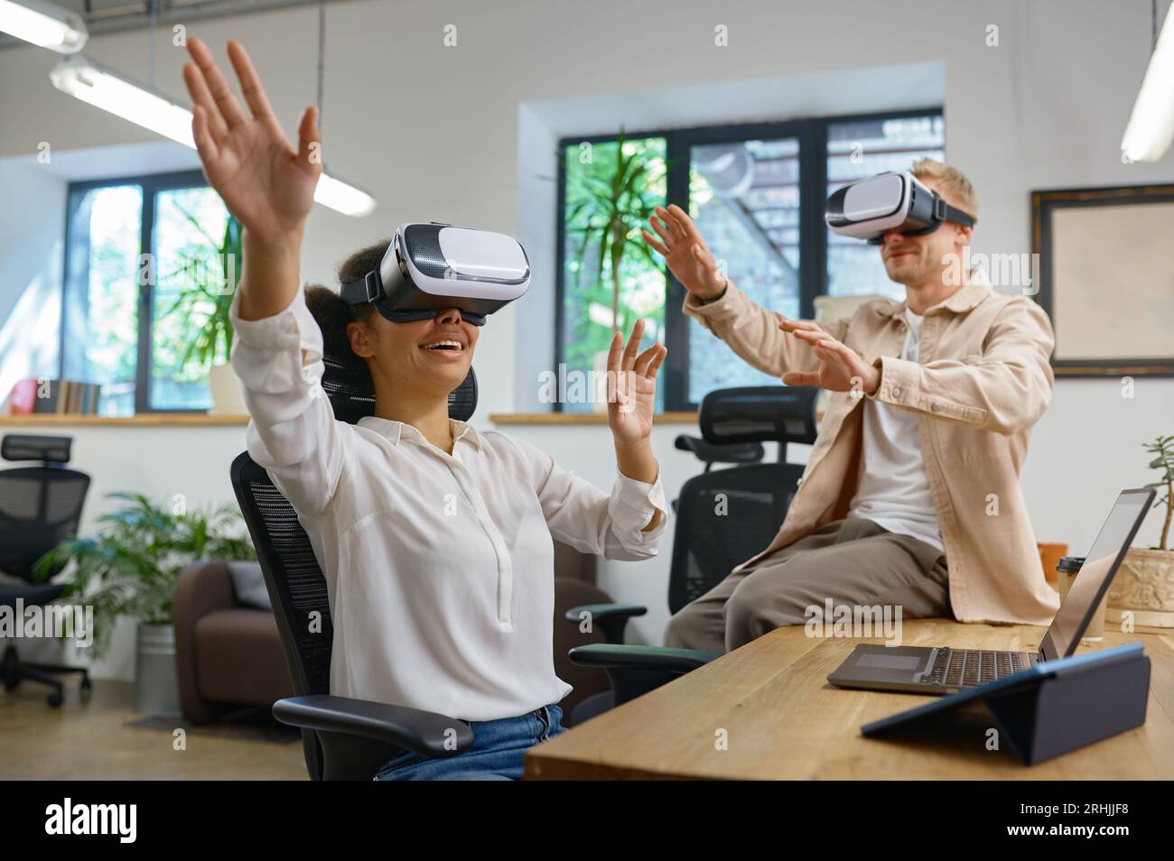 Inspired man and woman coworker wearing vr goggles in office Stock ...