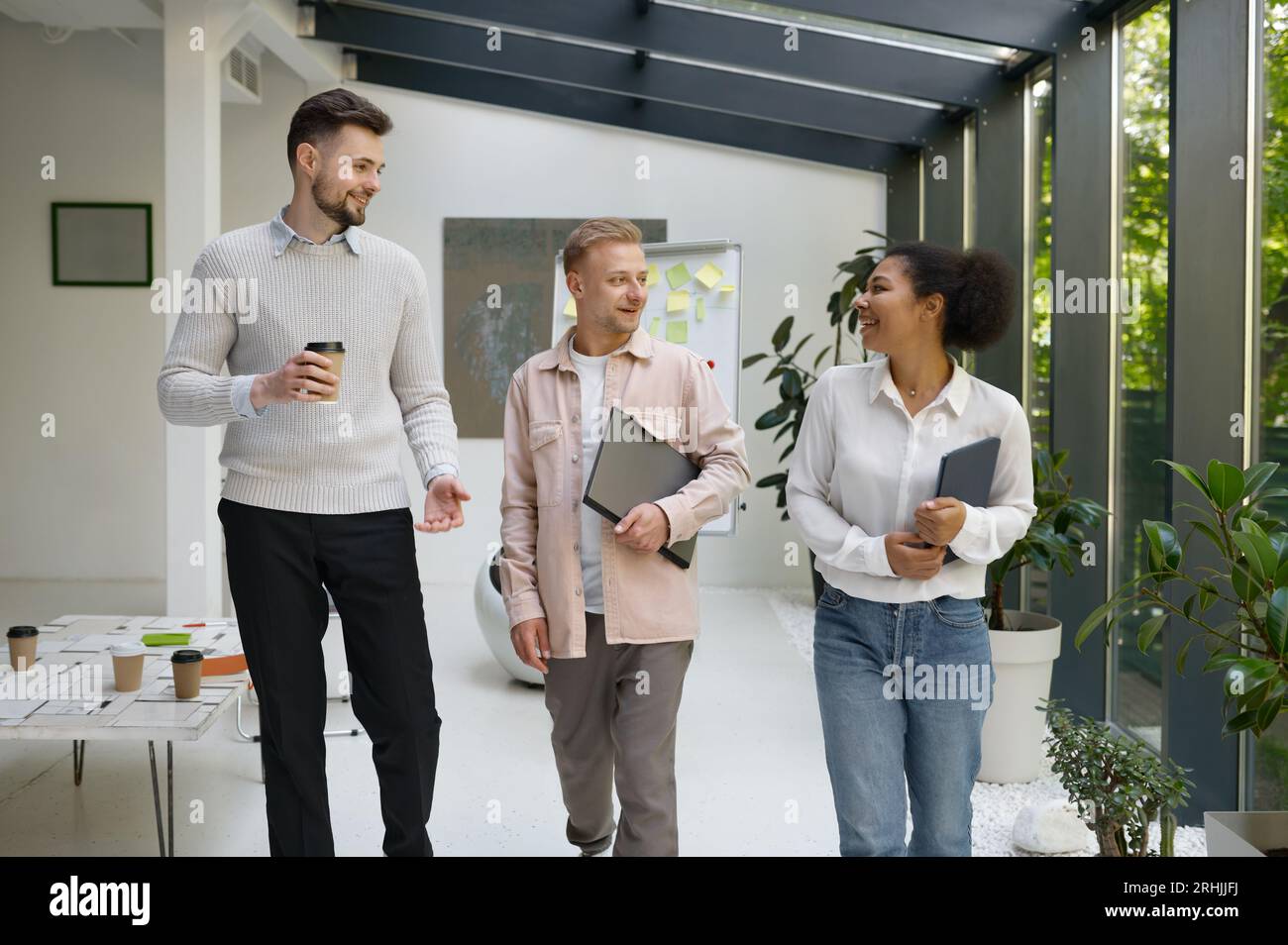 Colleague team going to office workstation after coffee break Stock ...