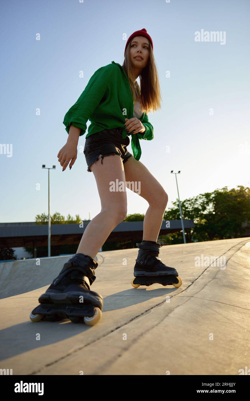 Active teenager girl rollerskater riding at outdoor rollerdrom Stock ...