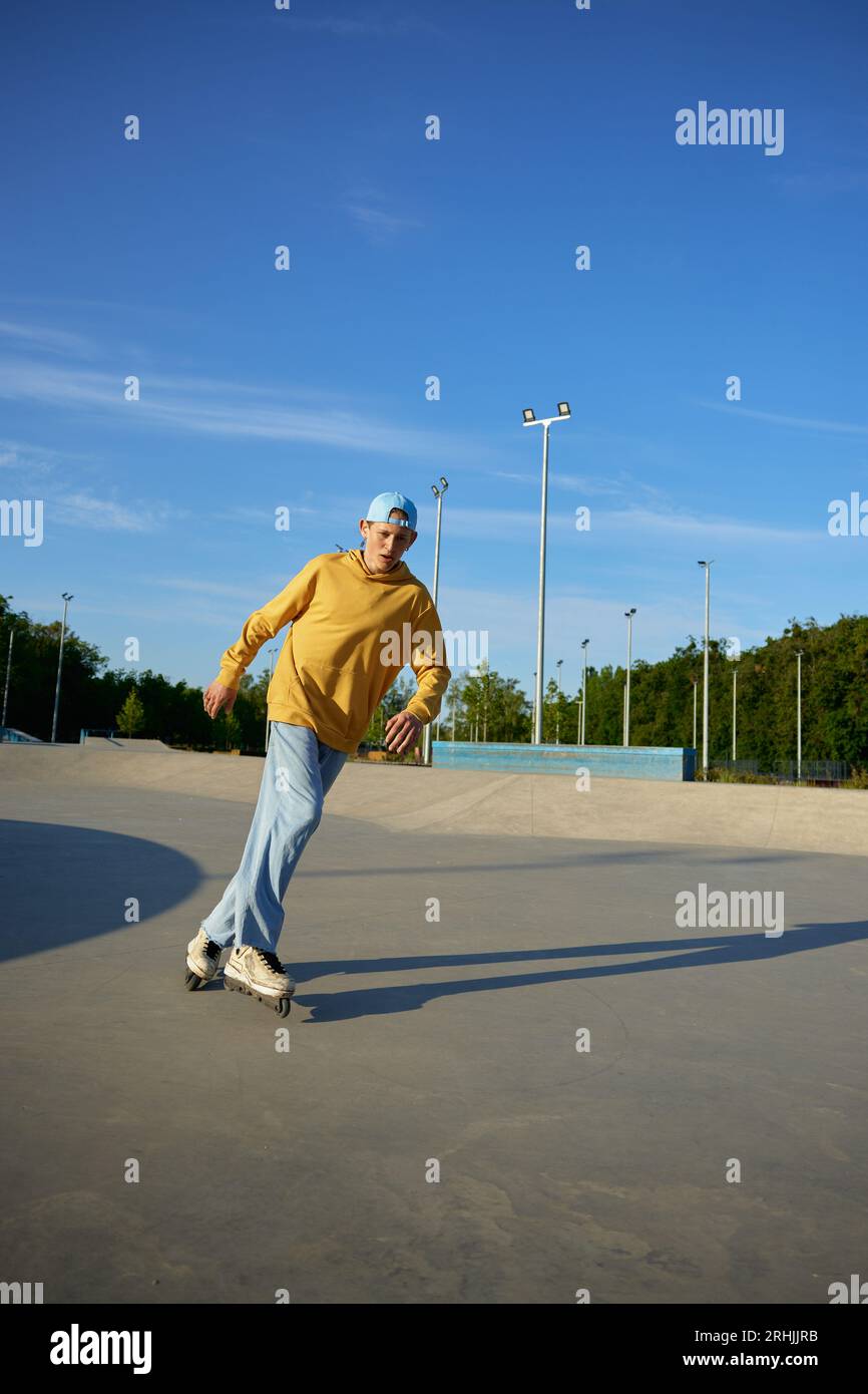 Happy teenager boy skating on outdoors rollerdrom Stock Photo - Alamy