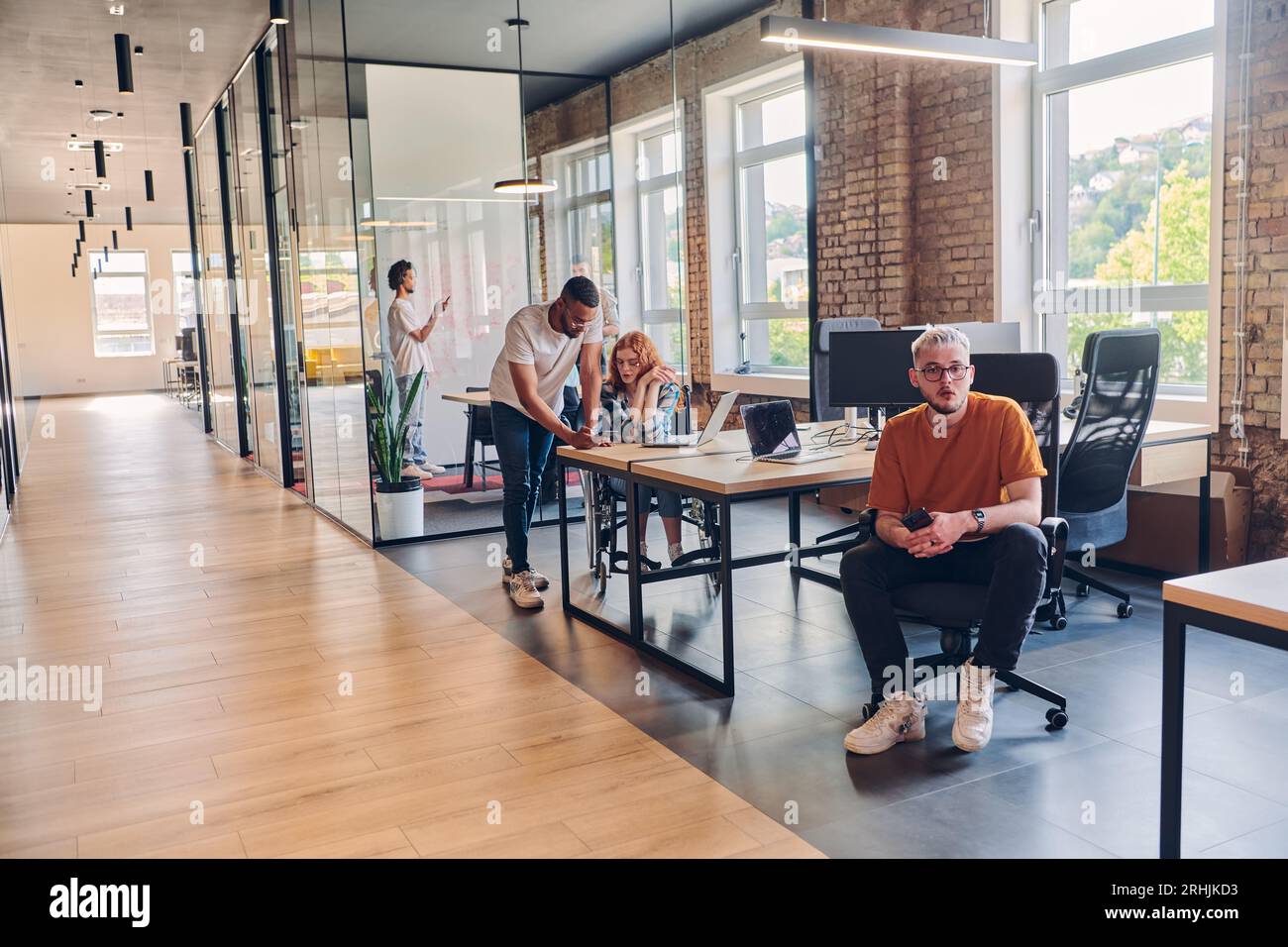 A diverse group of business professionals collaborates in a modern ...